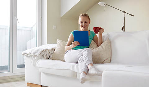 happy woman with tablet pc drinking tea at home | Mary Lindemuth ...